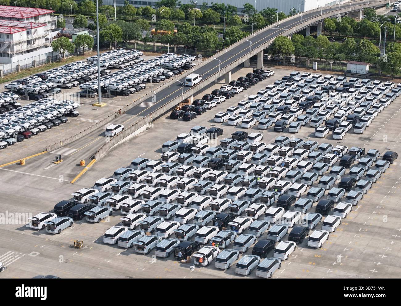 New cars wait for shipment at the logistics center of a plant of SAIC ...