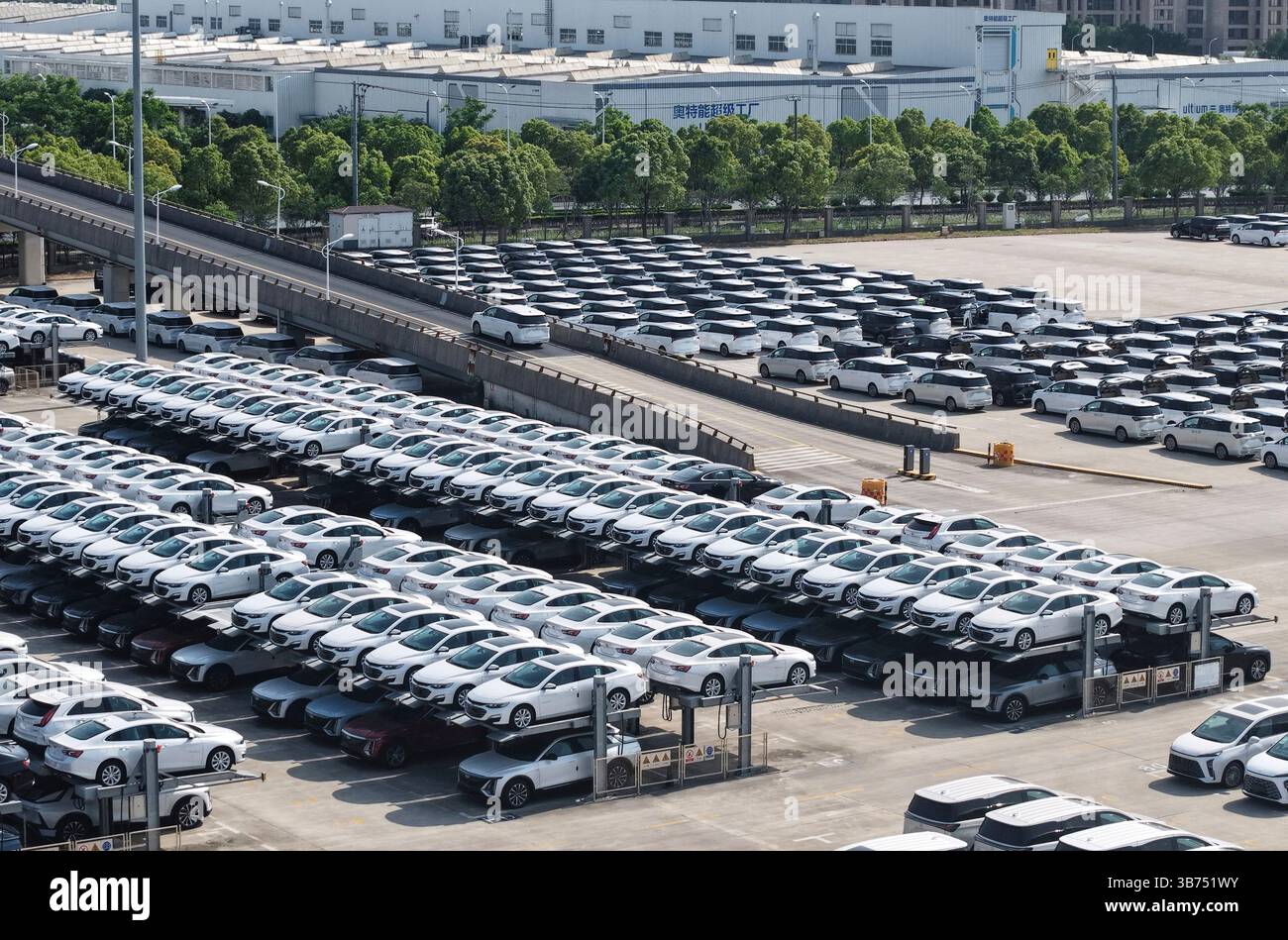 New cars wait for shipment at the logistics center of a plant of SAIC ...