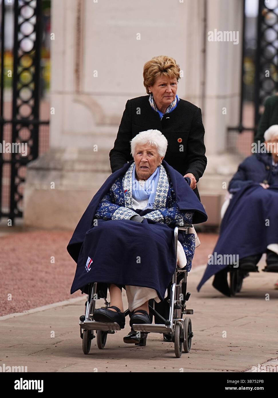 Second World War veteran Joy Trew is escorted into Buckingham Palace ...