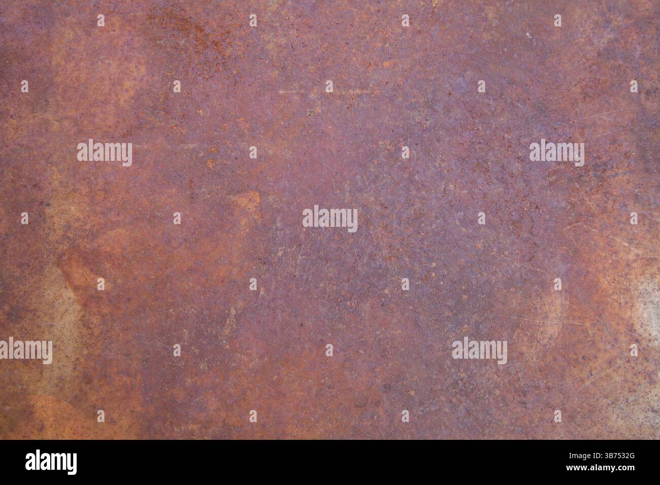 Close-up of a rusty metal sheet with rich, textured corrosion patterns. Industrial background ...