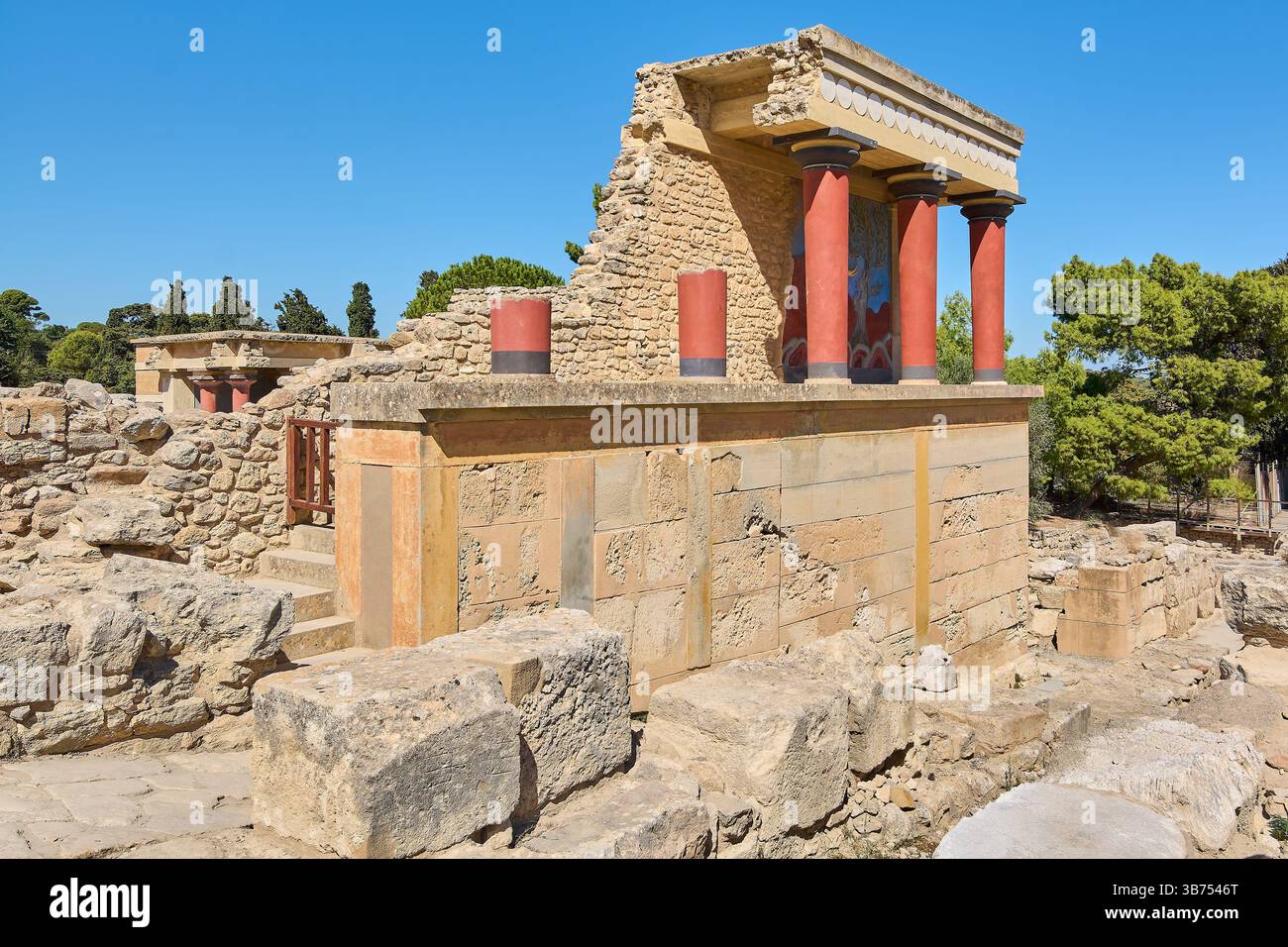 Ancient red columns and weathered stone walls stand in the ruins of ...