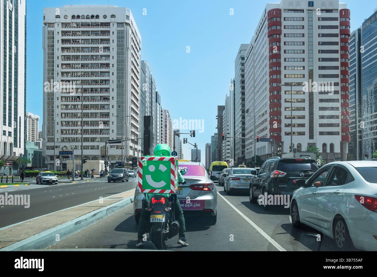 Abu Dhabi, UAE. View of a wide street with busy car traffic among ...