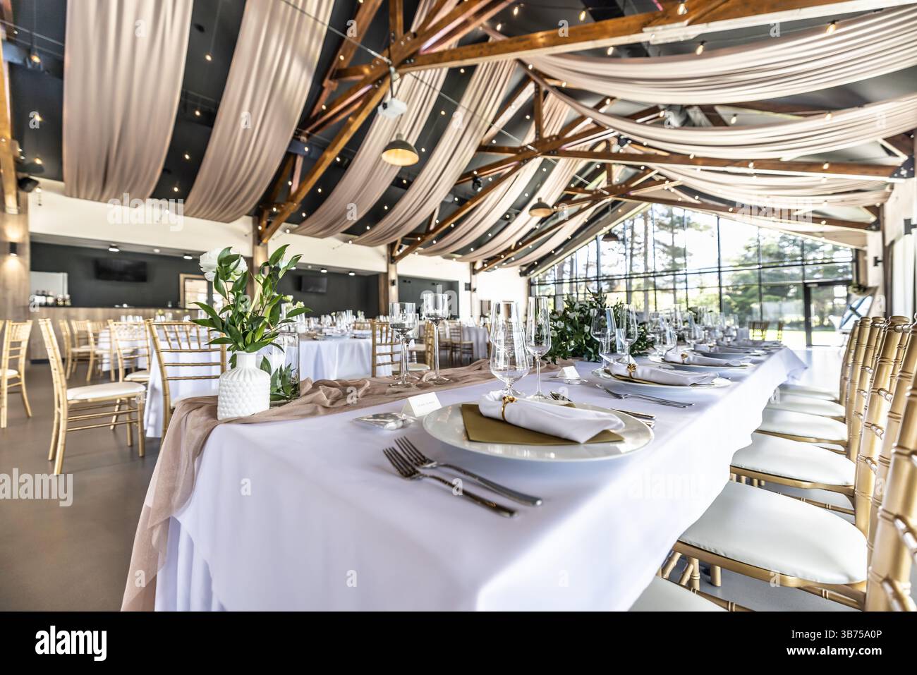 Wedding setting and decorated tables in a beautiful modern interior of ...