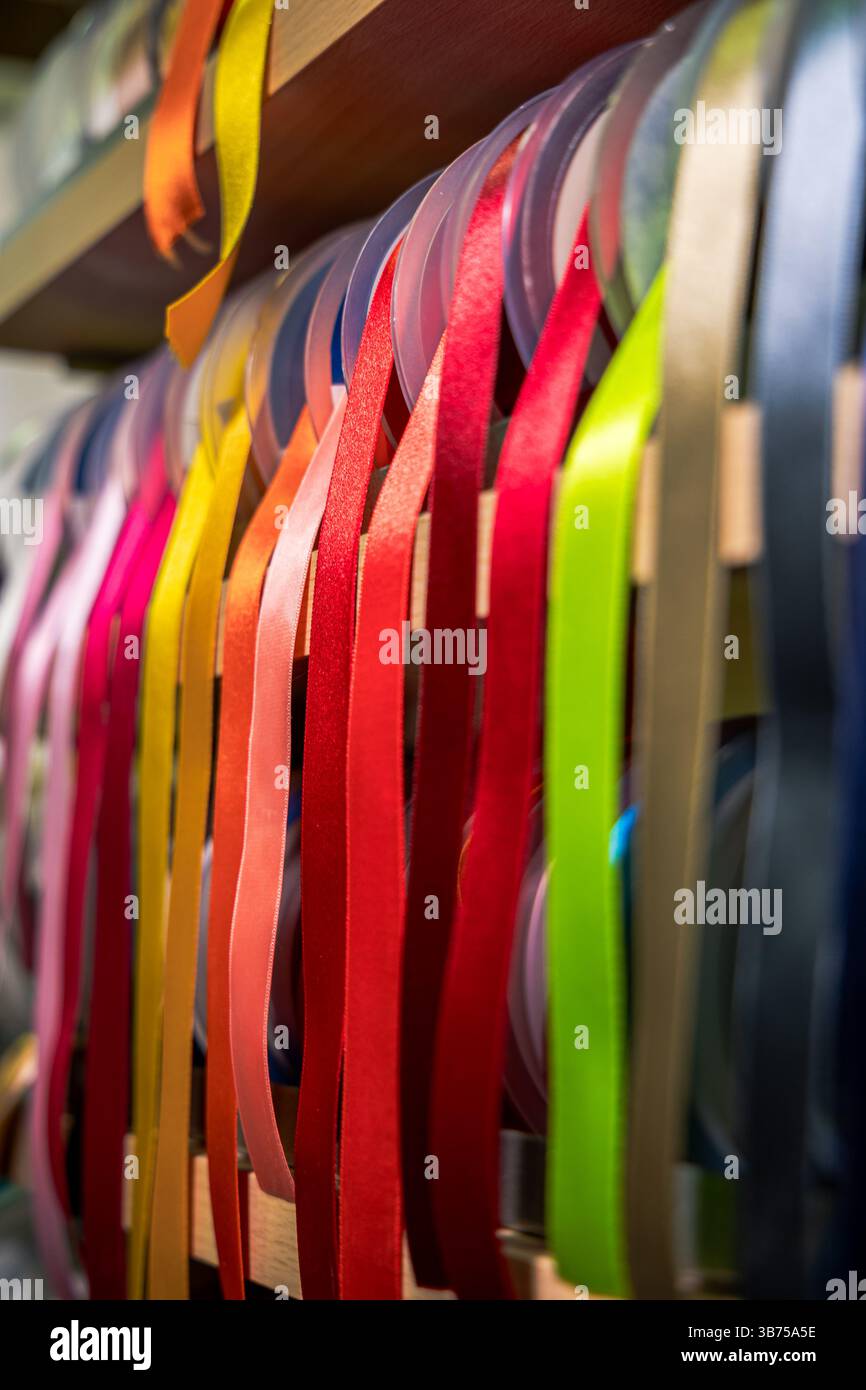 This vertically framed close-up captures a vivid lineup of satin ...