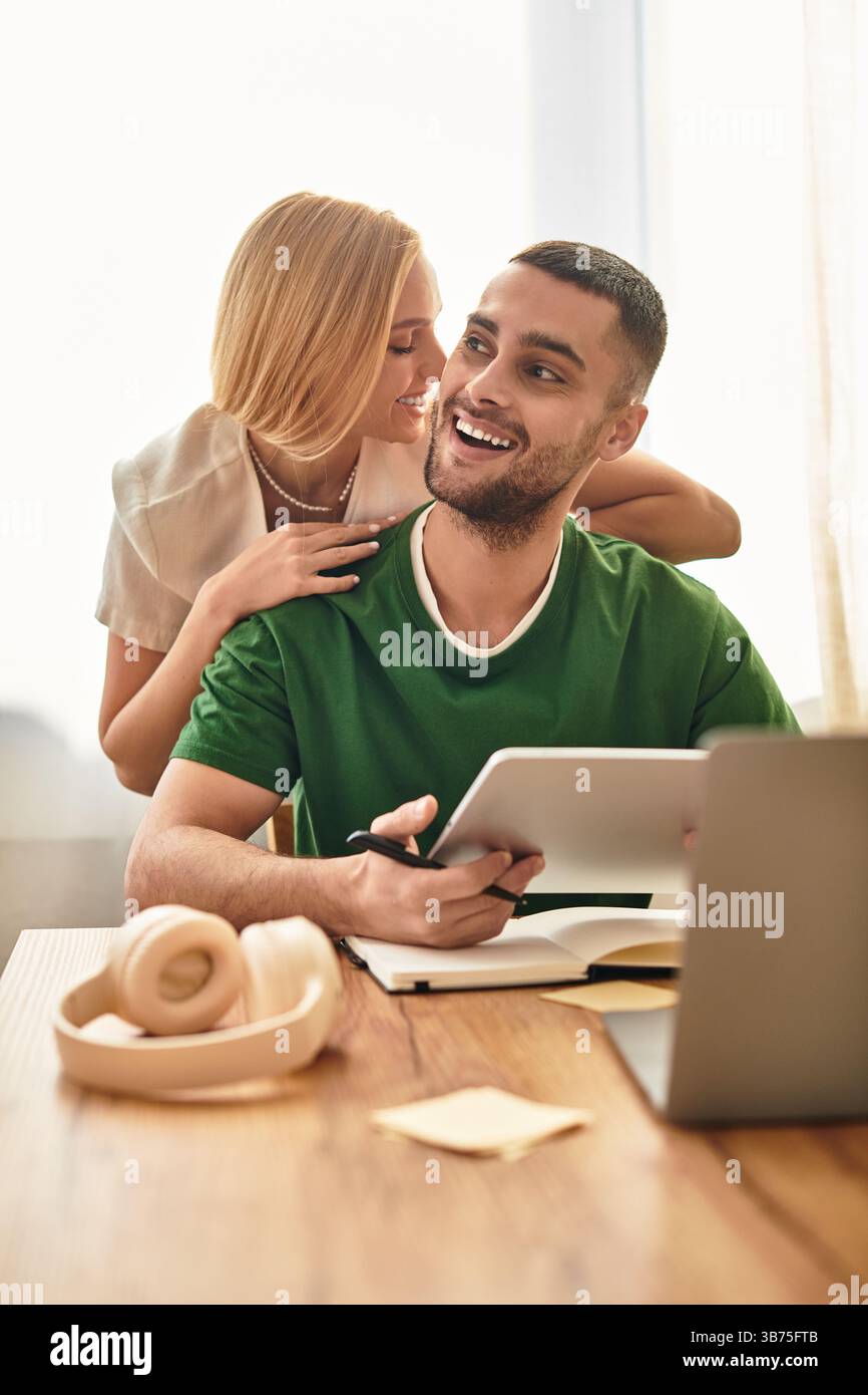 A couple shares laughter and affection at home while enjoying creative ...