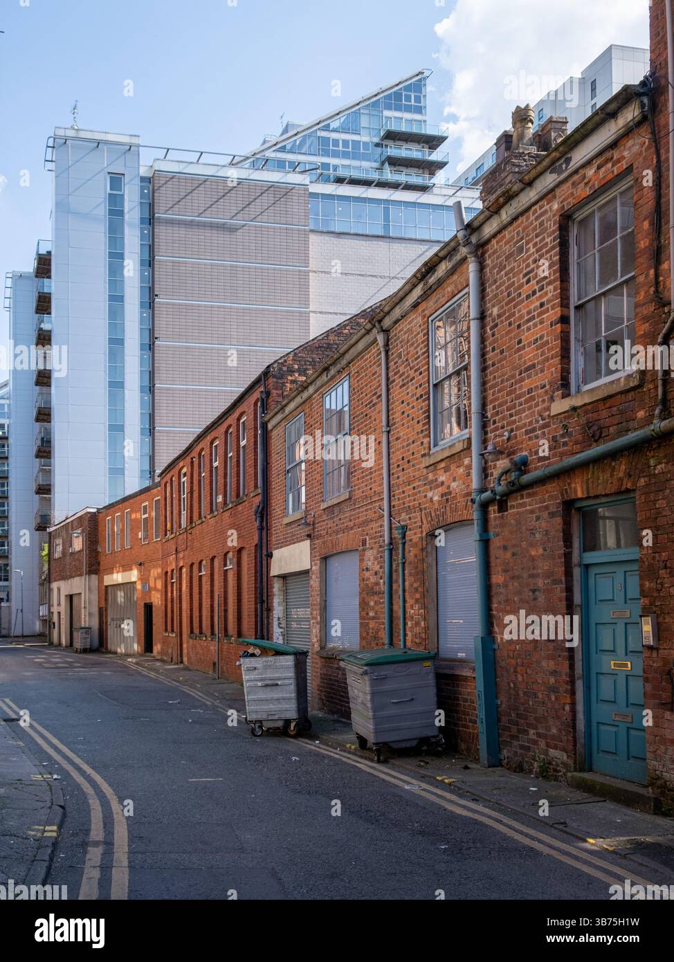 Terraced red brick houses in back street, contrasted with modern ...