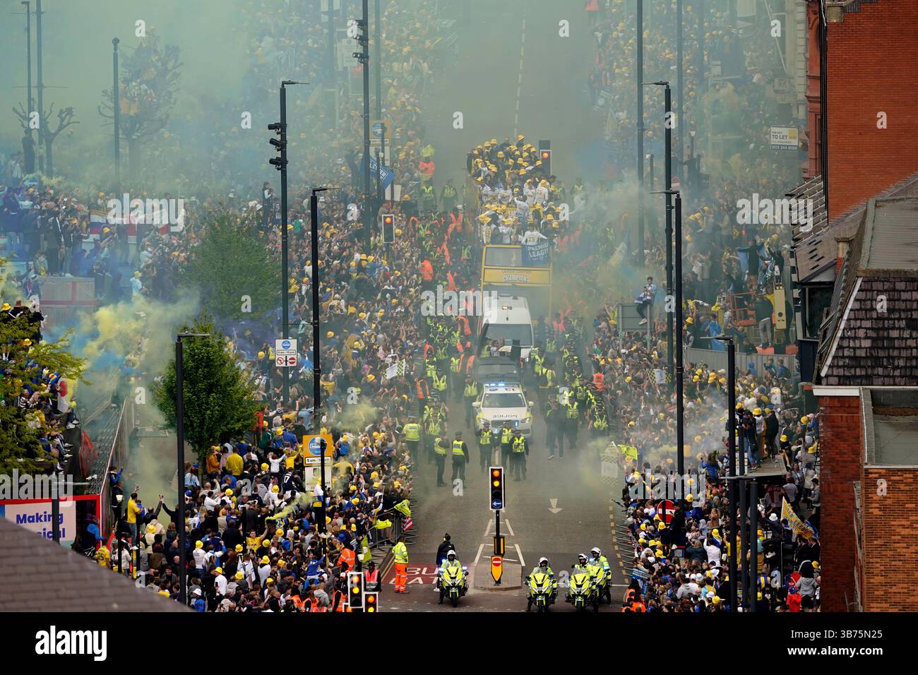 Fans line the street as the Leeds United parade buses enter the city ...