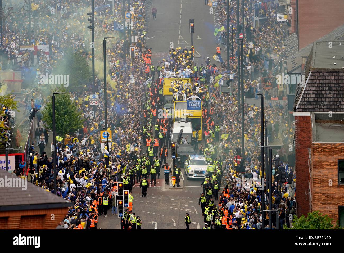 Fans line the street as the Leeds United parade buses enter the city ...