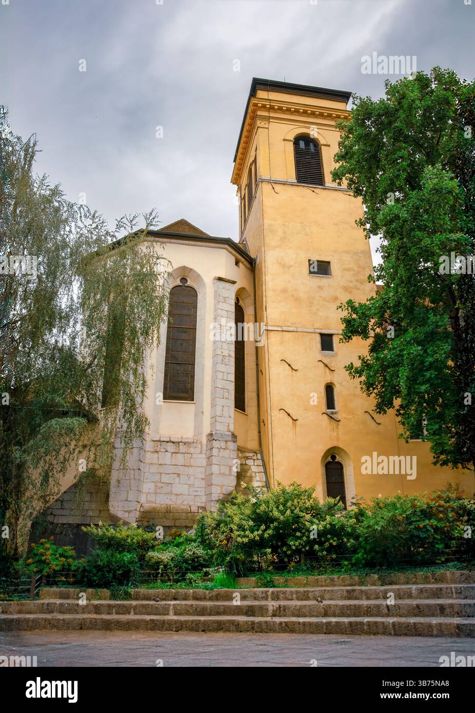 Old yellow church among trees Stock Photo - Alamy