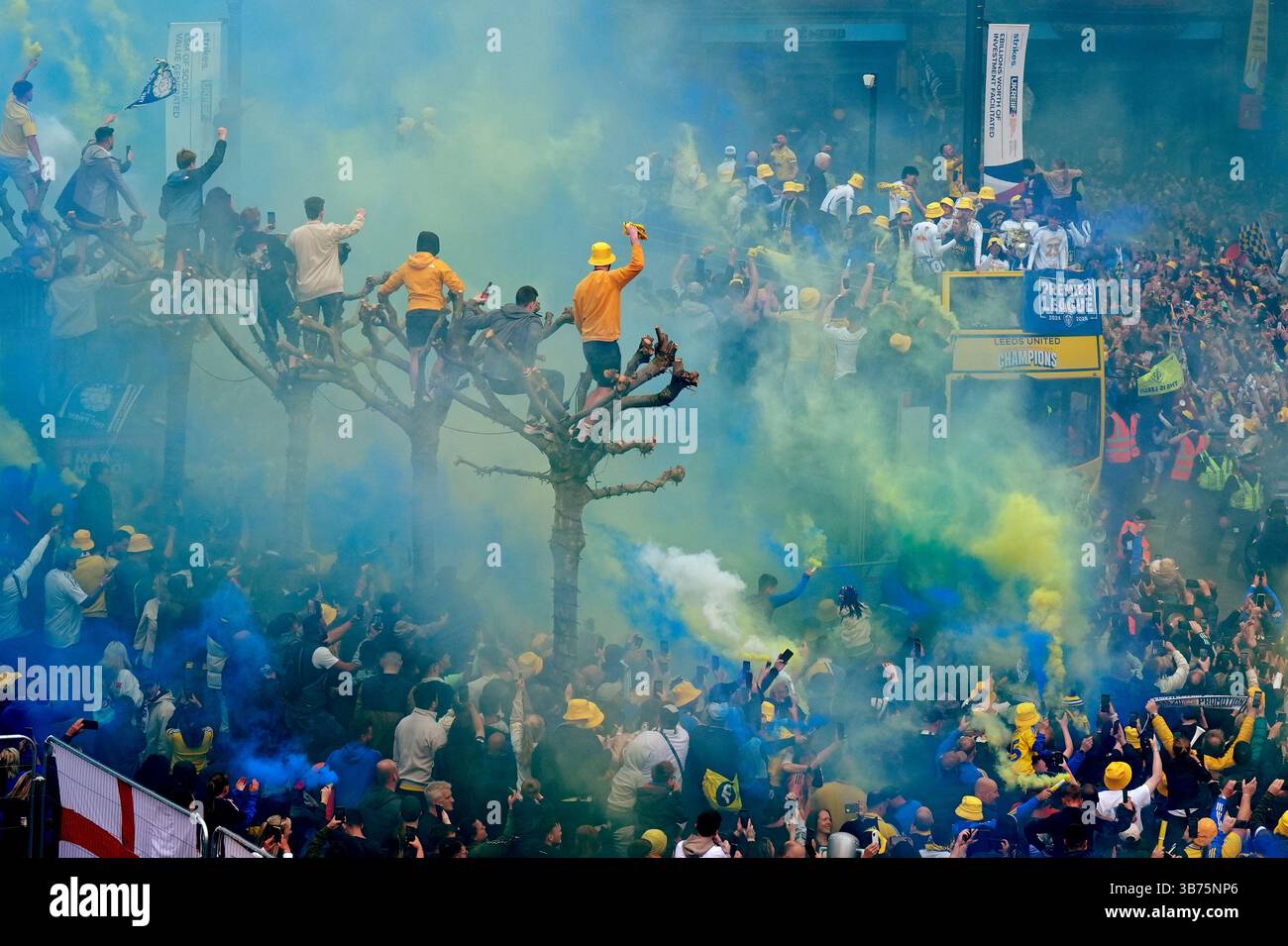 Fans line the street as the Leeds United parade buses enter the city ...