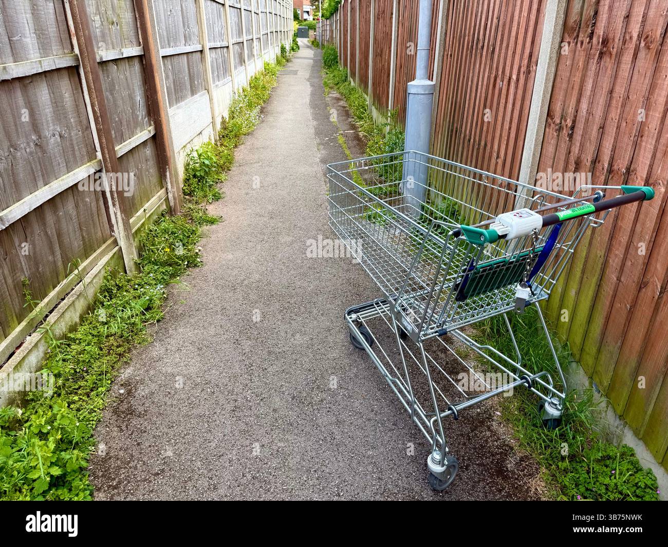 An abandoned supermarket shopping trolley on an urban housing estate in ...