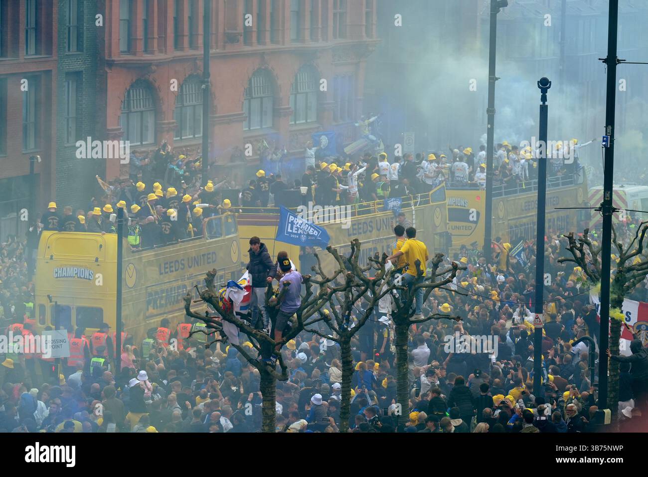 Fans line the street as the Leeds United parade buses enter the city ...