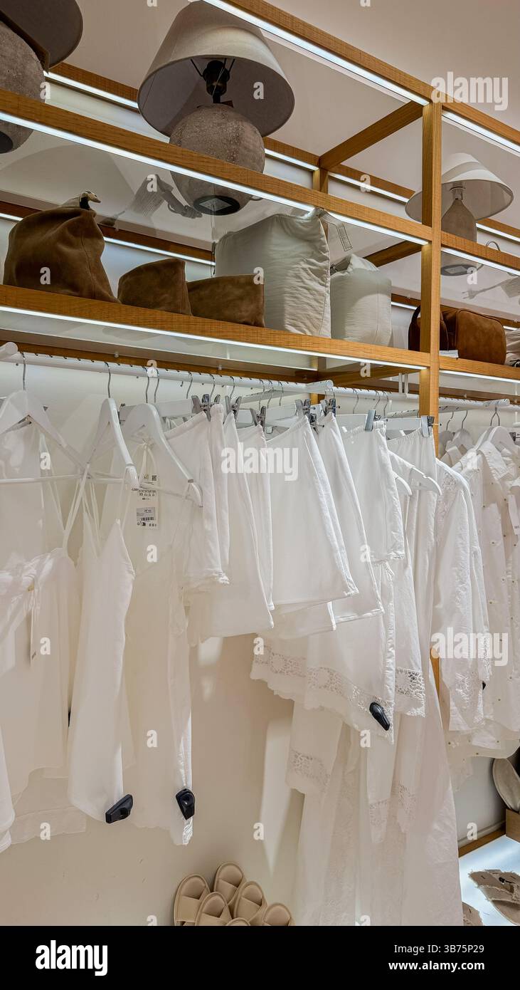 Elegant white linen clothes and accessories in modern boutique ...