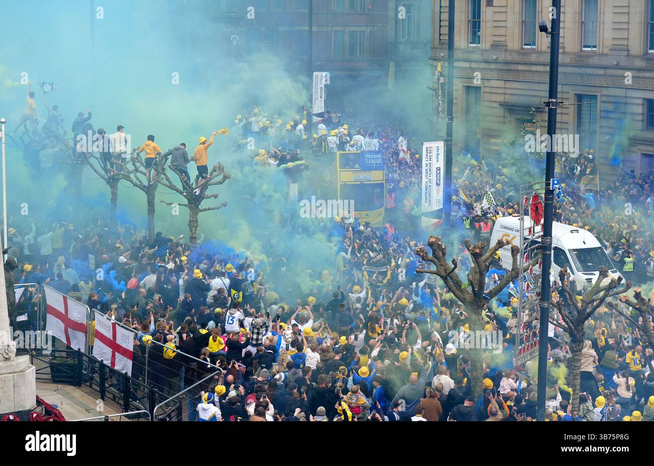 Fans line the street as the Leeds United parade buses enter the city ...