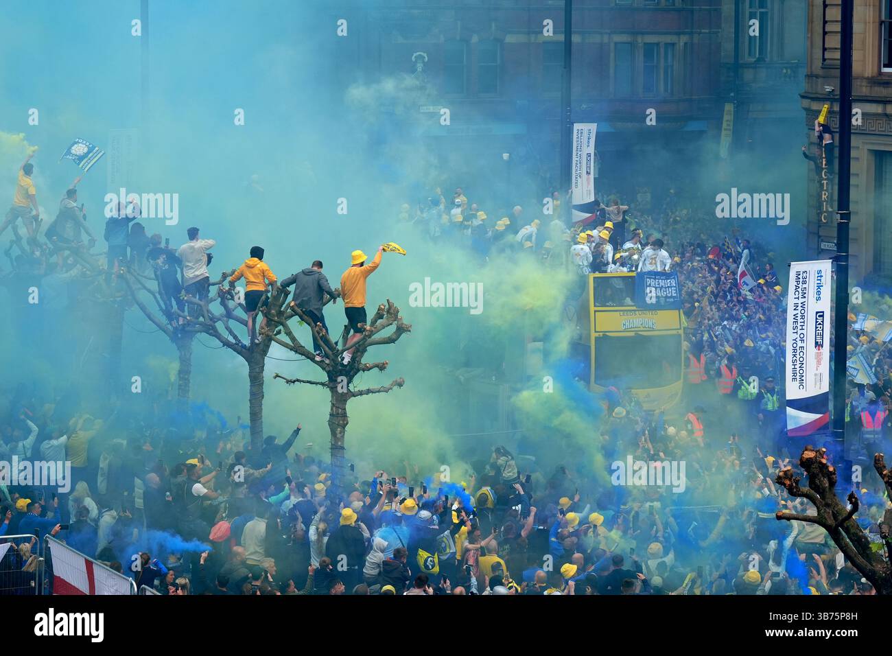Fans line the street as the Leeds United parade buses enter the city ...