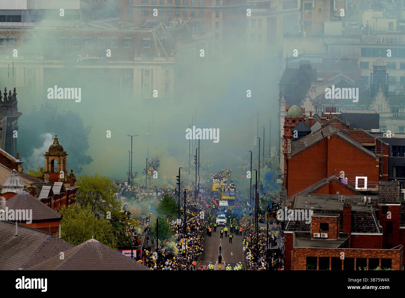 Fans line the street as the Leeds United parade buses enter the city ...