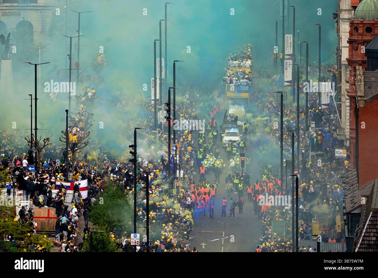 Fans line the street as the Leeds United parade buses enter the city ...