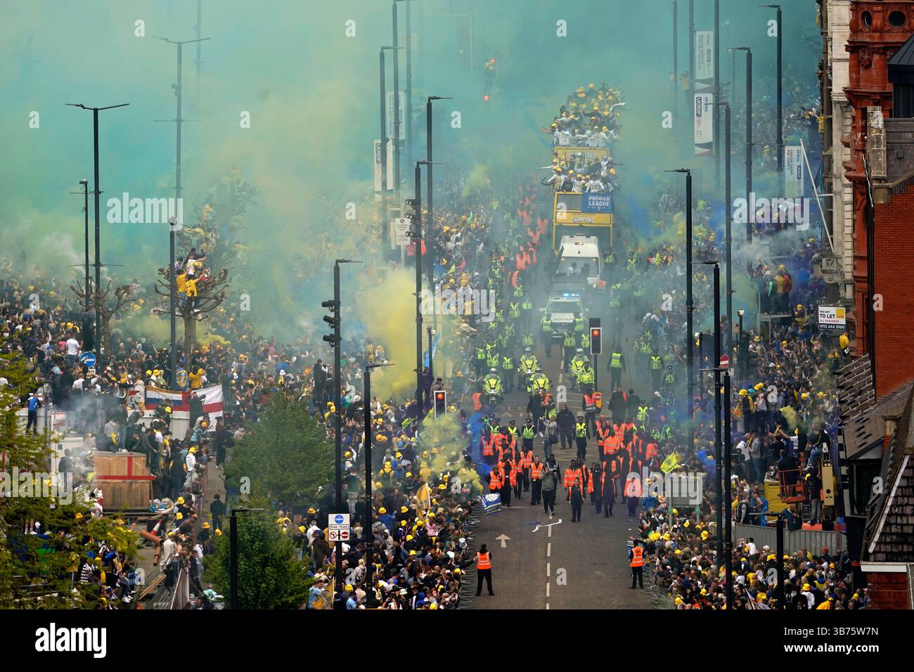 Fans line the street as the Leeds United parade buses enter the city ...