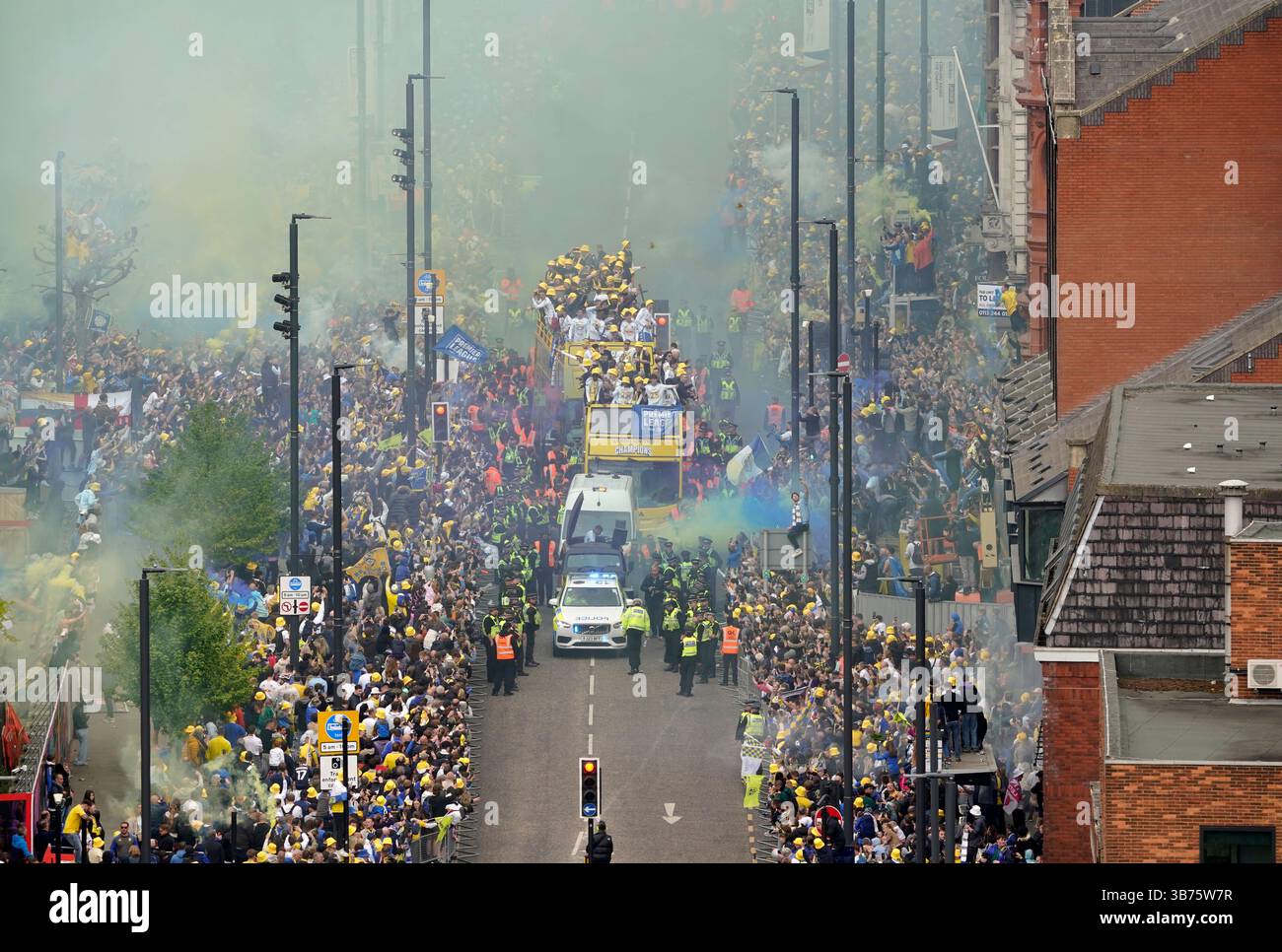 Fans line the street as the Leeds United parade buses enter the city ...