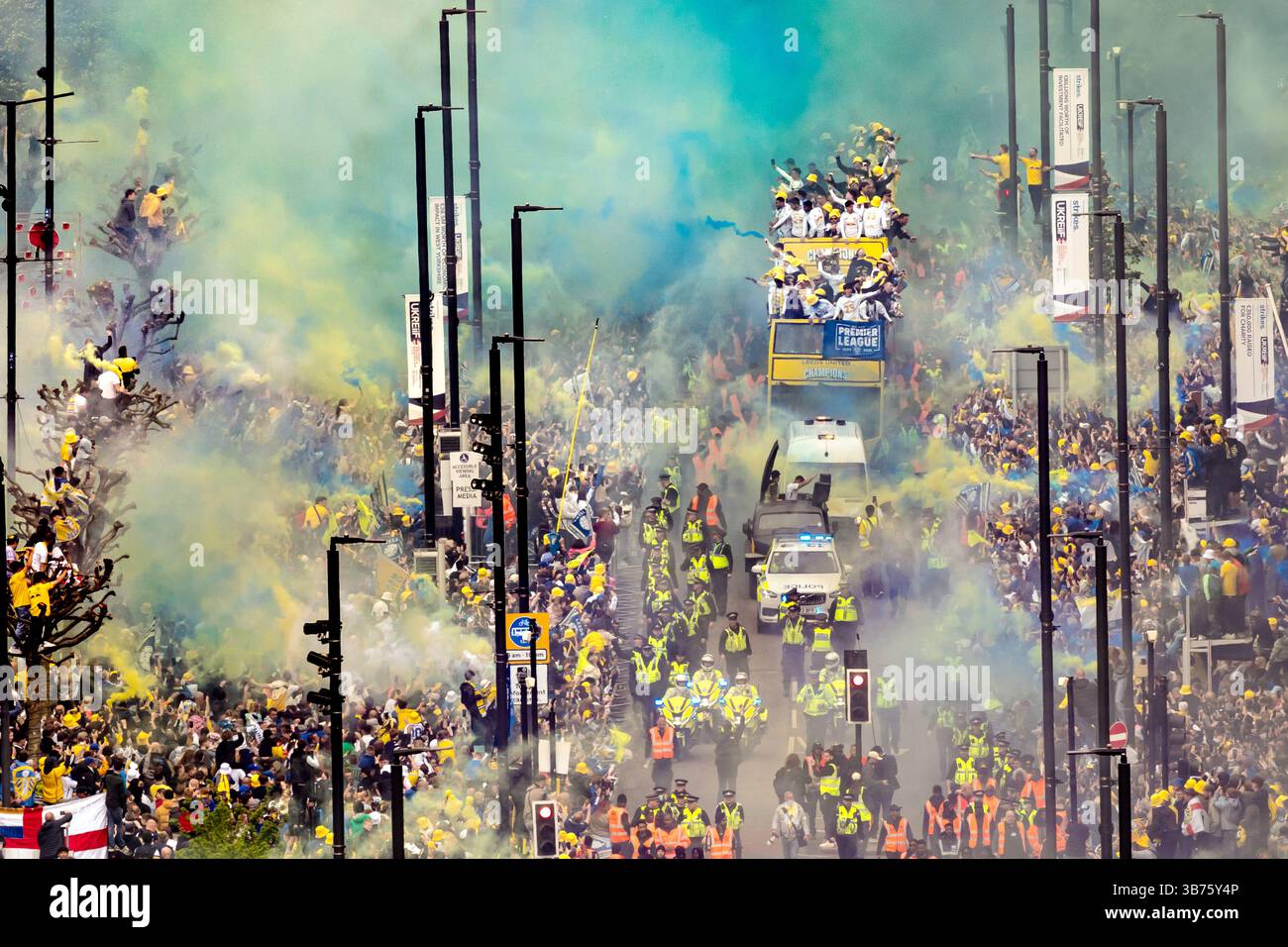 Fans line the street as the Leeds United parade buses pass through the ...