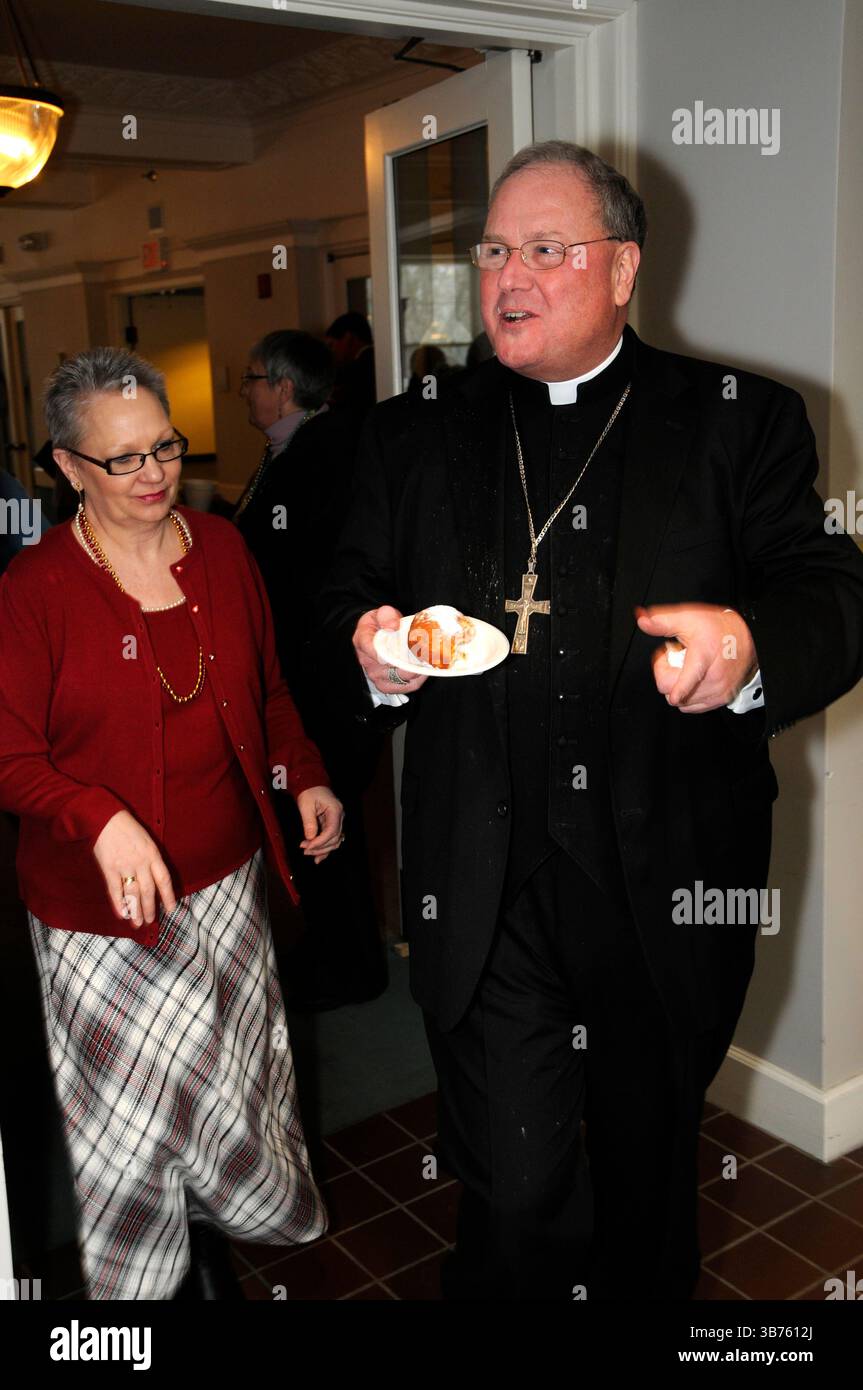 With paczki in hand, Archbishop Timothy Dolan arrives at a breakfast ...