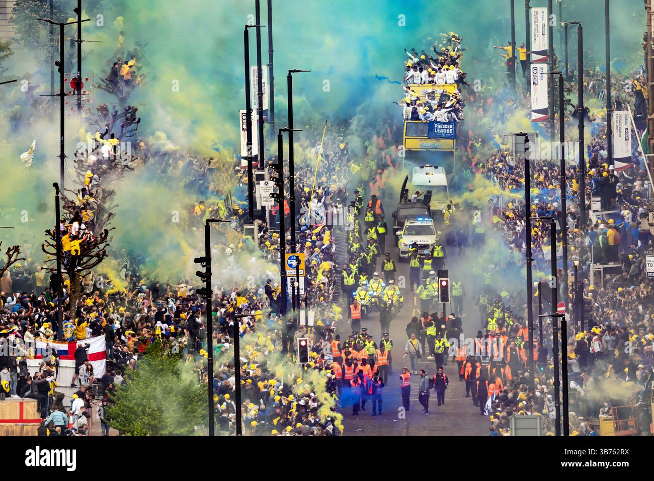 Fans line the street as the Leeds United parade buses pass through the ...