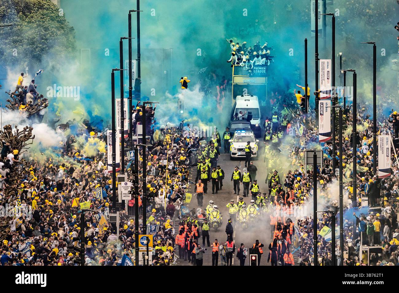 Fans line the street as the Leeds United parade buses pass through the ...