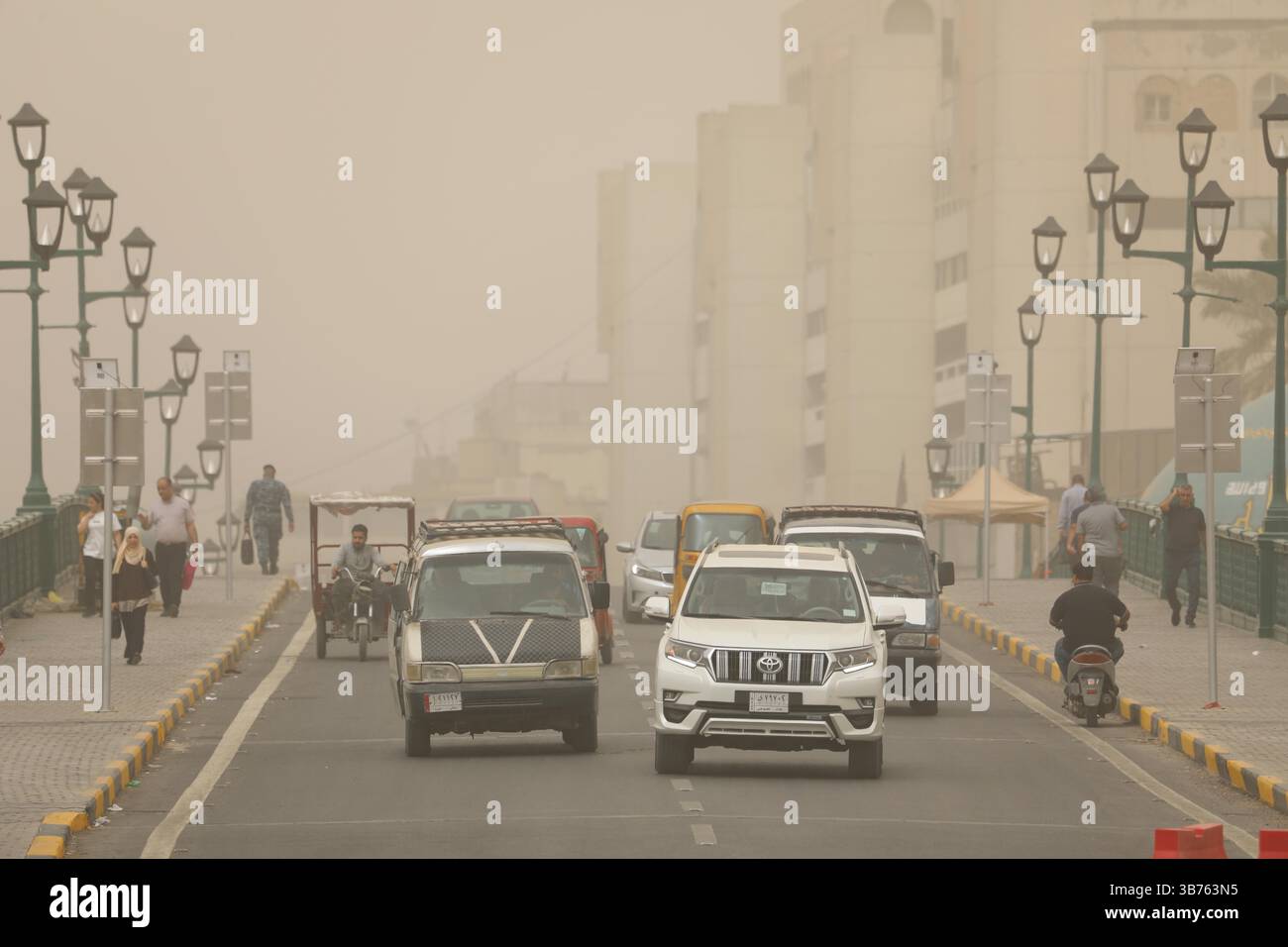 Baghdad, Iraq. 5th May, 2025. Cars run on a road in a sandstorm in ...