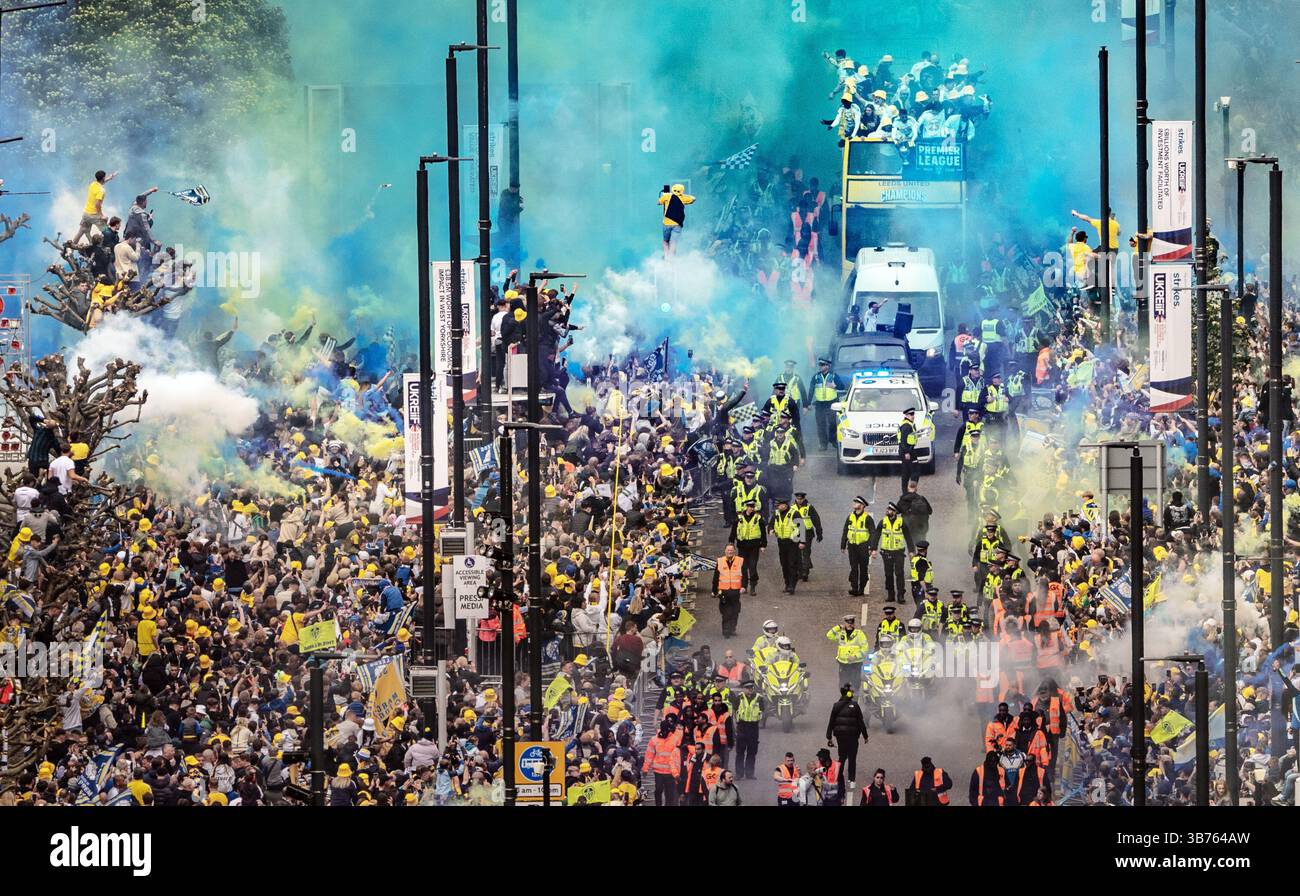 Fans line the street as the Leeds United parade buses pass through the ...