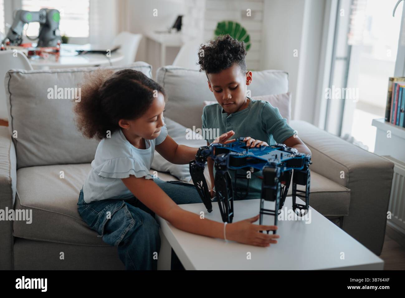 Kids building their first homemade robot at home Stock Photo - Alamy