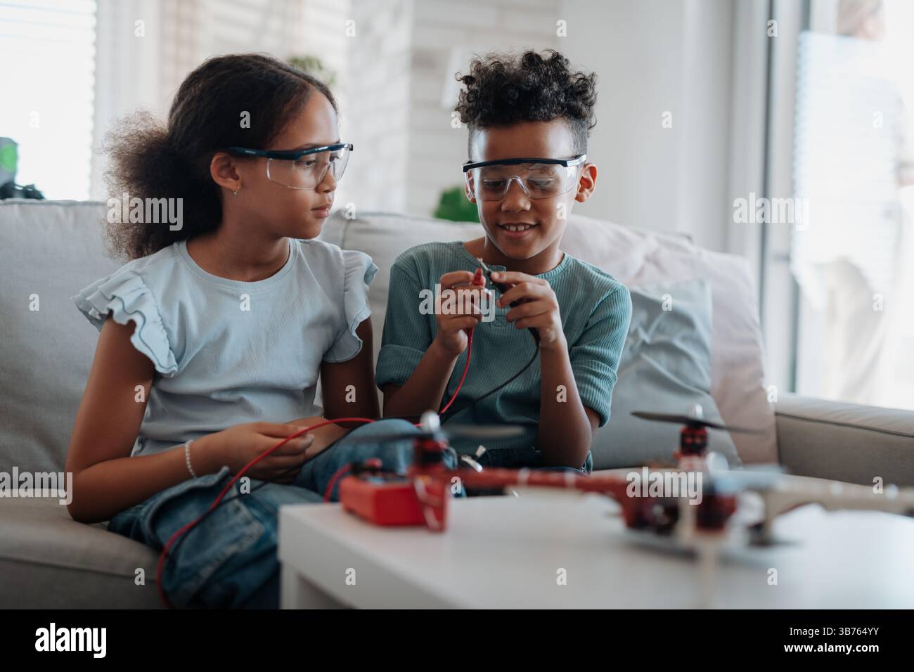 Kids building their first homemade robot at home Stock Photo - Alamy