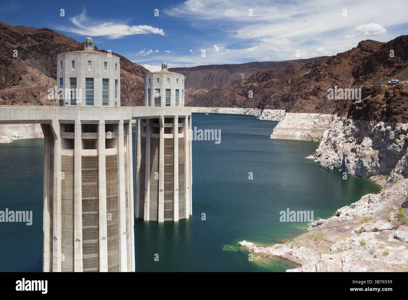 Hoover Dam Towers on the blue Lake Mead. Hoover Dam is a concrete arch ...