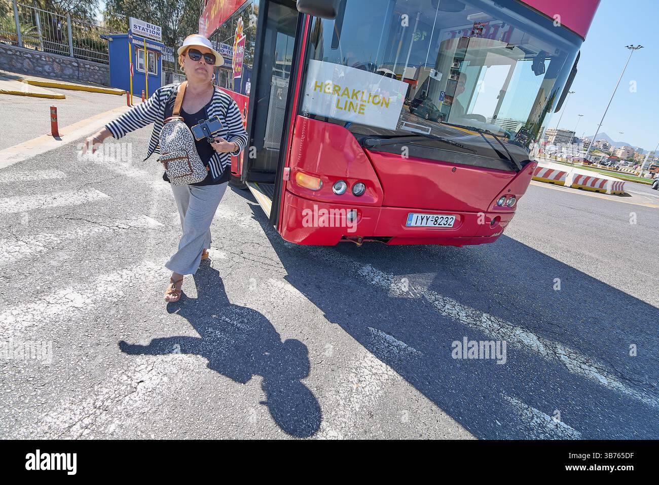Crete.Greece - may 05, 2025: Red Public Bus and Traveler in Motion ...