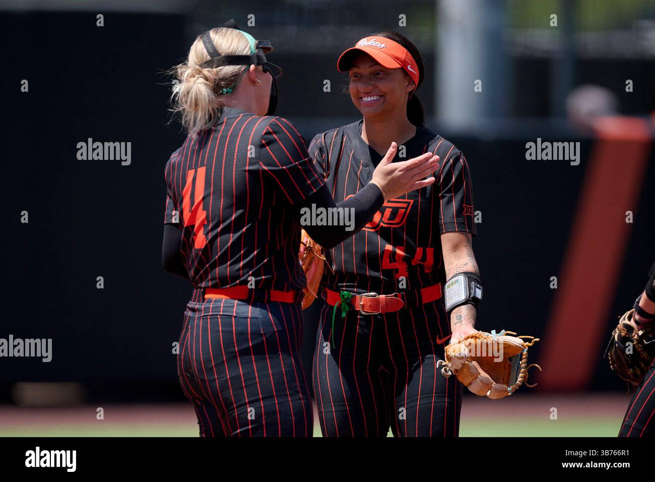 Oklahoma State Cowgirls pitcher RyLee Crandall (4) high fives third ...