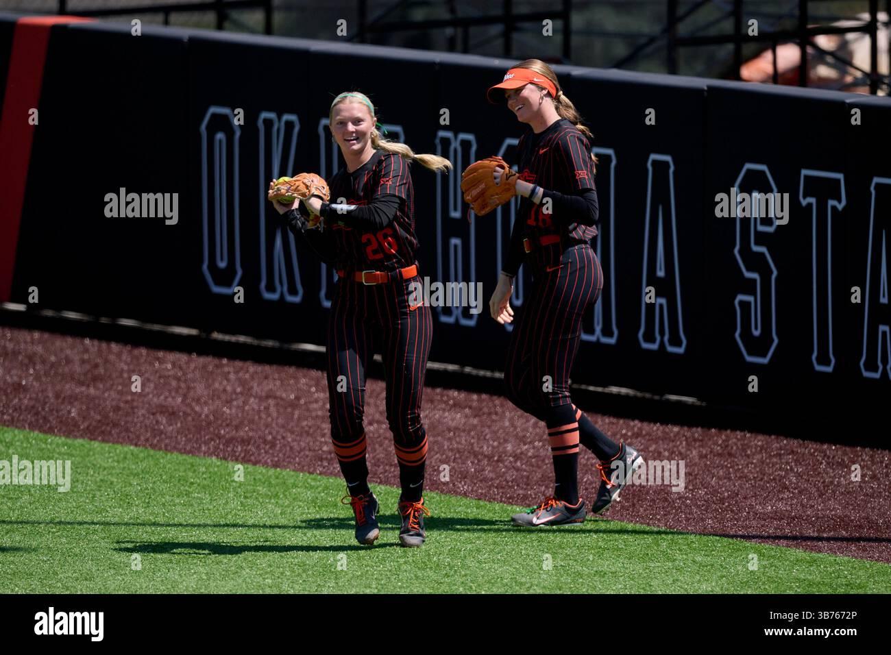 Oklahoma State Cowgirls second baseman Rosie Davis (26) and outfielder ...