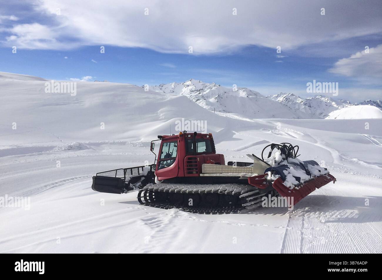 Modern red snow groomer on the empty slope Stock Photo - Alamy