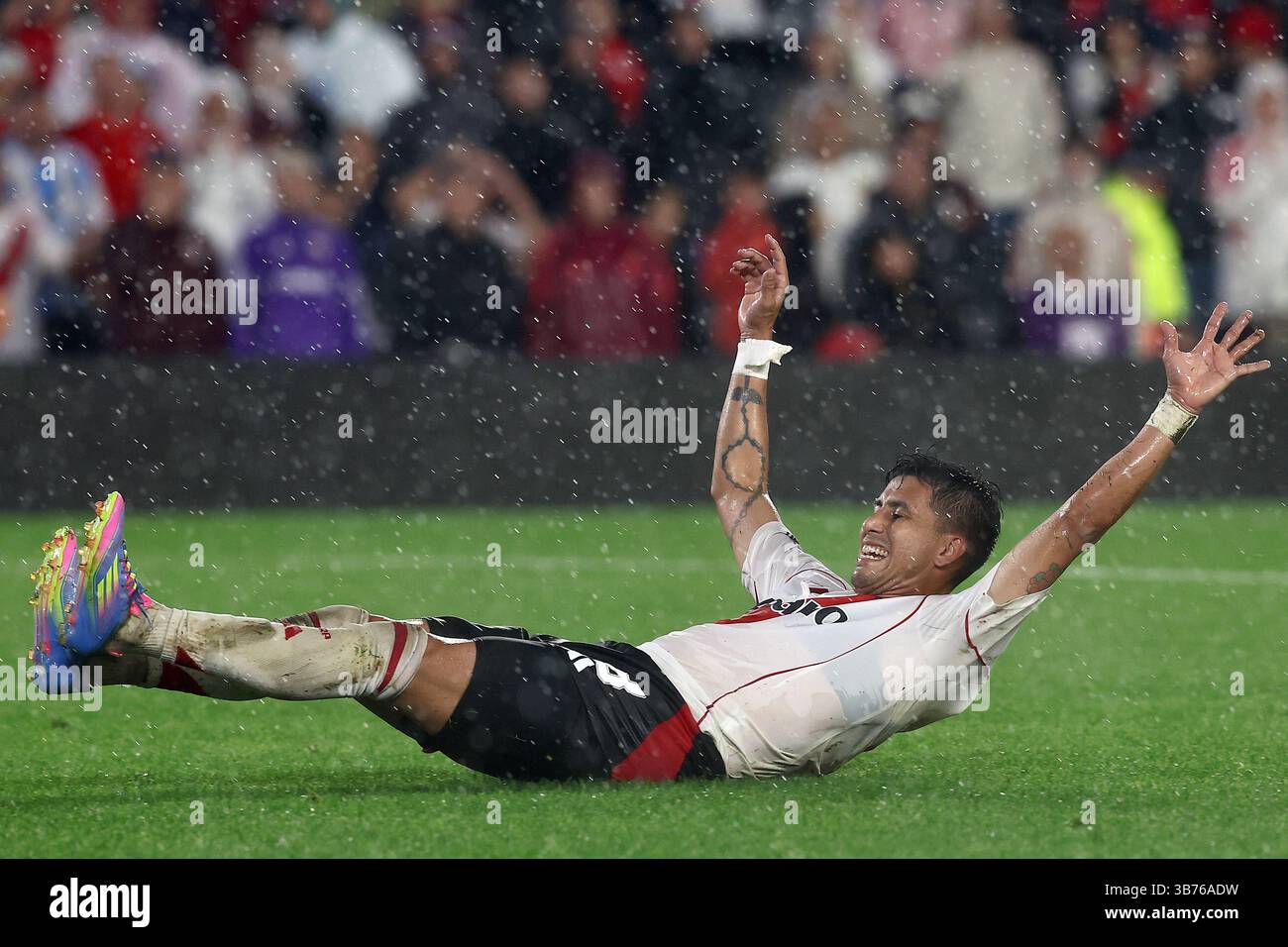 River Plate s midfielder Maximiliano Meza slides on the rain soaked ...