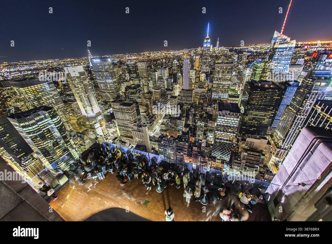 People look at the night view from Rockefeller Center Observation Deck ...