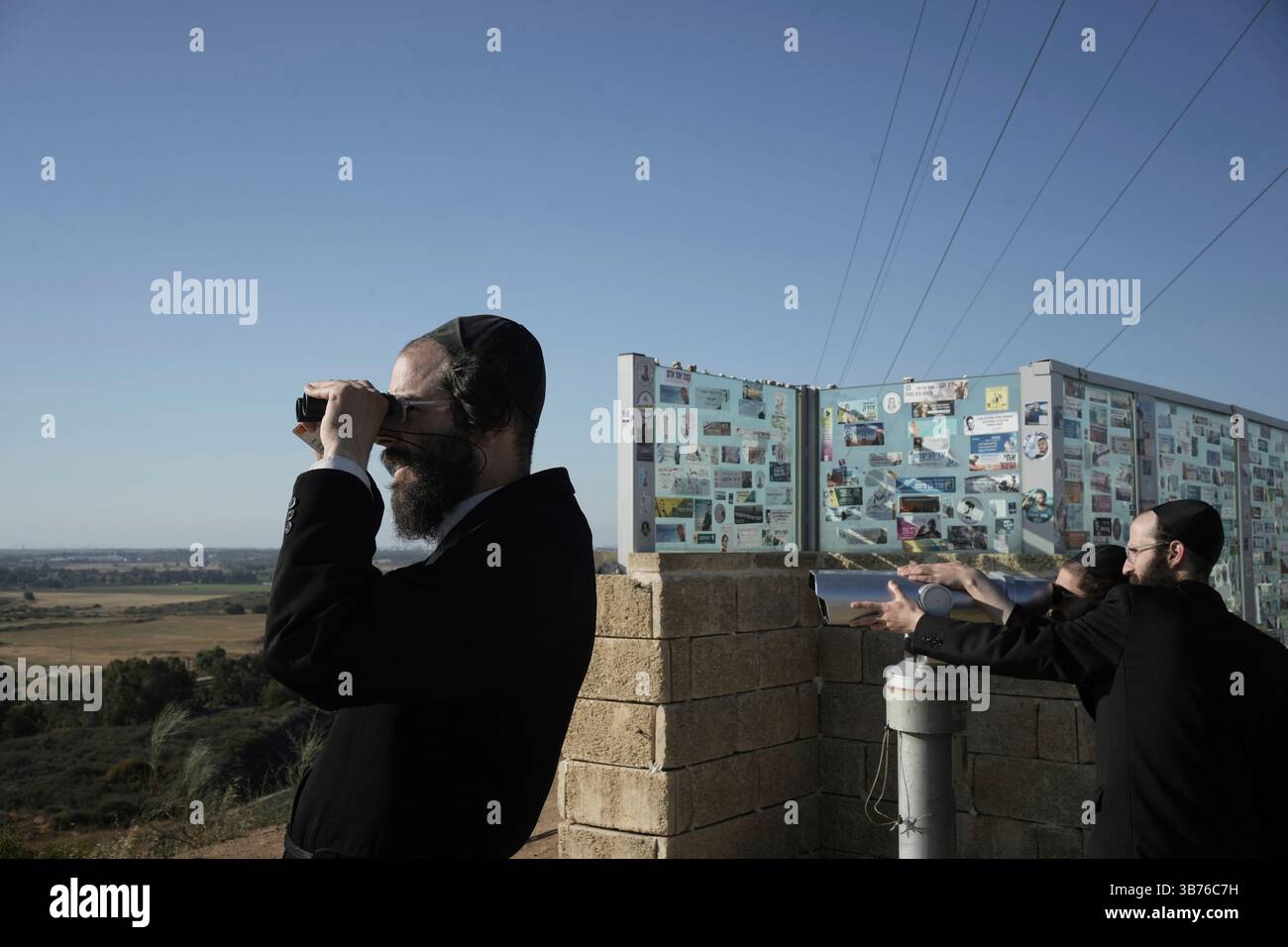 Ultra-orthodox Jewish men look at the Gaza Strip from an observation ...