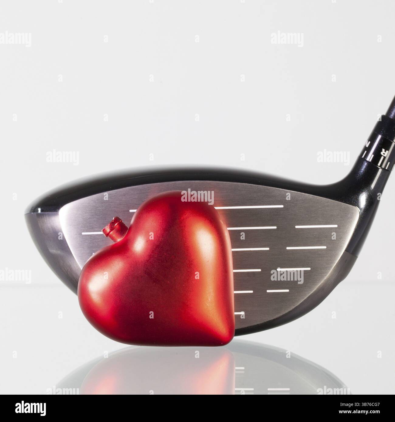 Golf driver and red heart on a glass desk Stock Photo - Alamy