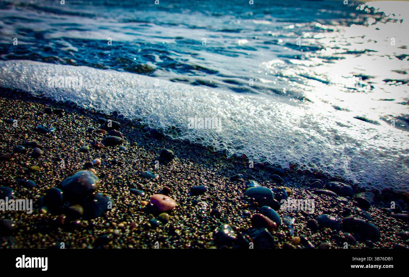 wave spume on the beach in Santorini Stock Photo - Alamy