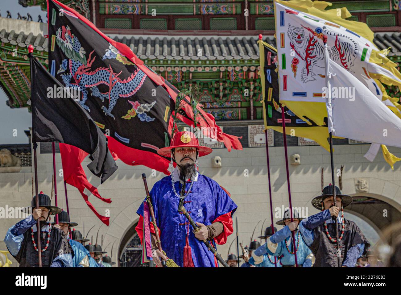 A royal guard carries a traditional flag during the Changing Ceremony ...