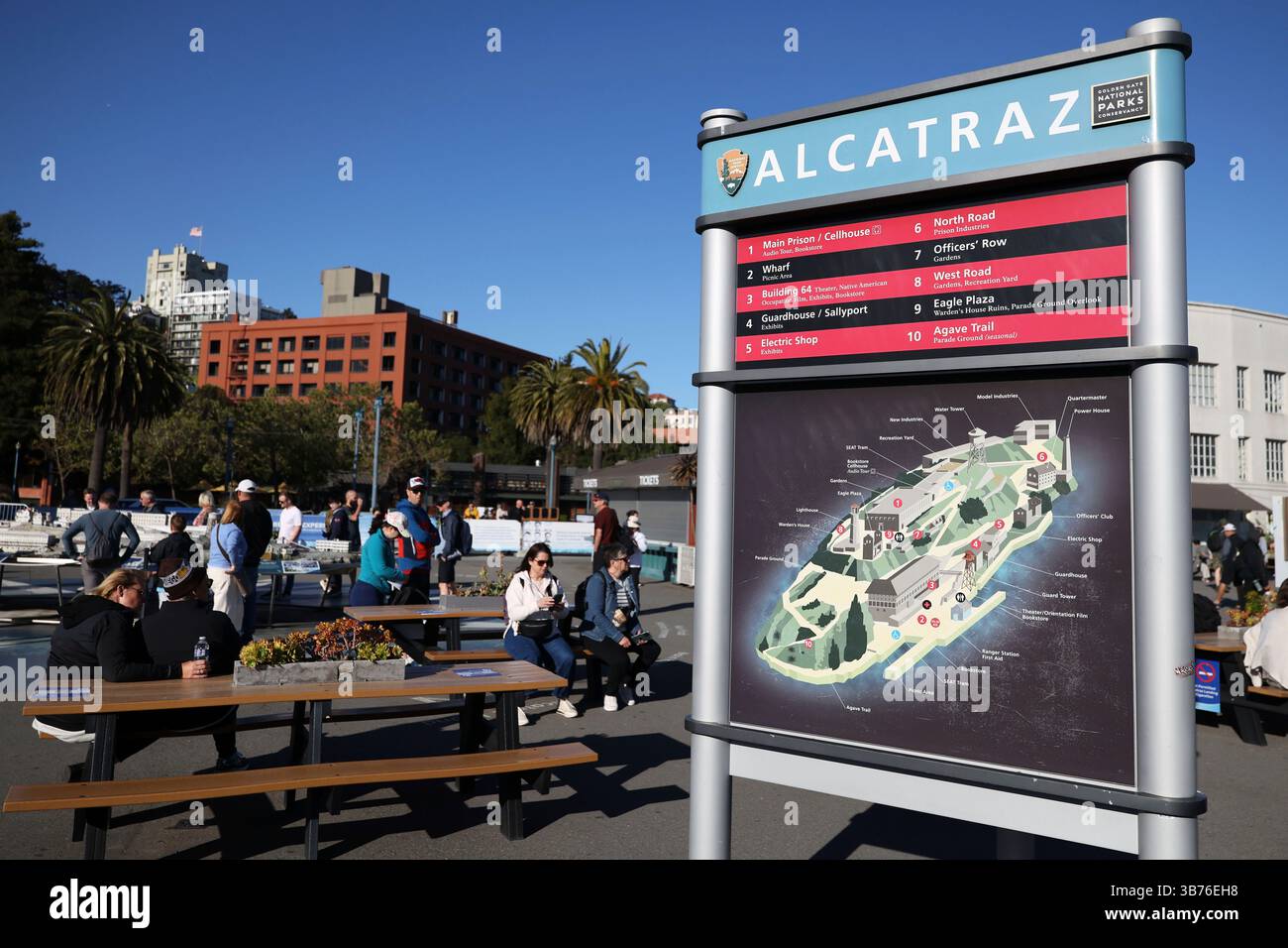 A map of Alcatraz is displayed in front of people waiting to board an ...