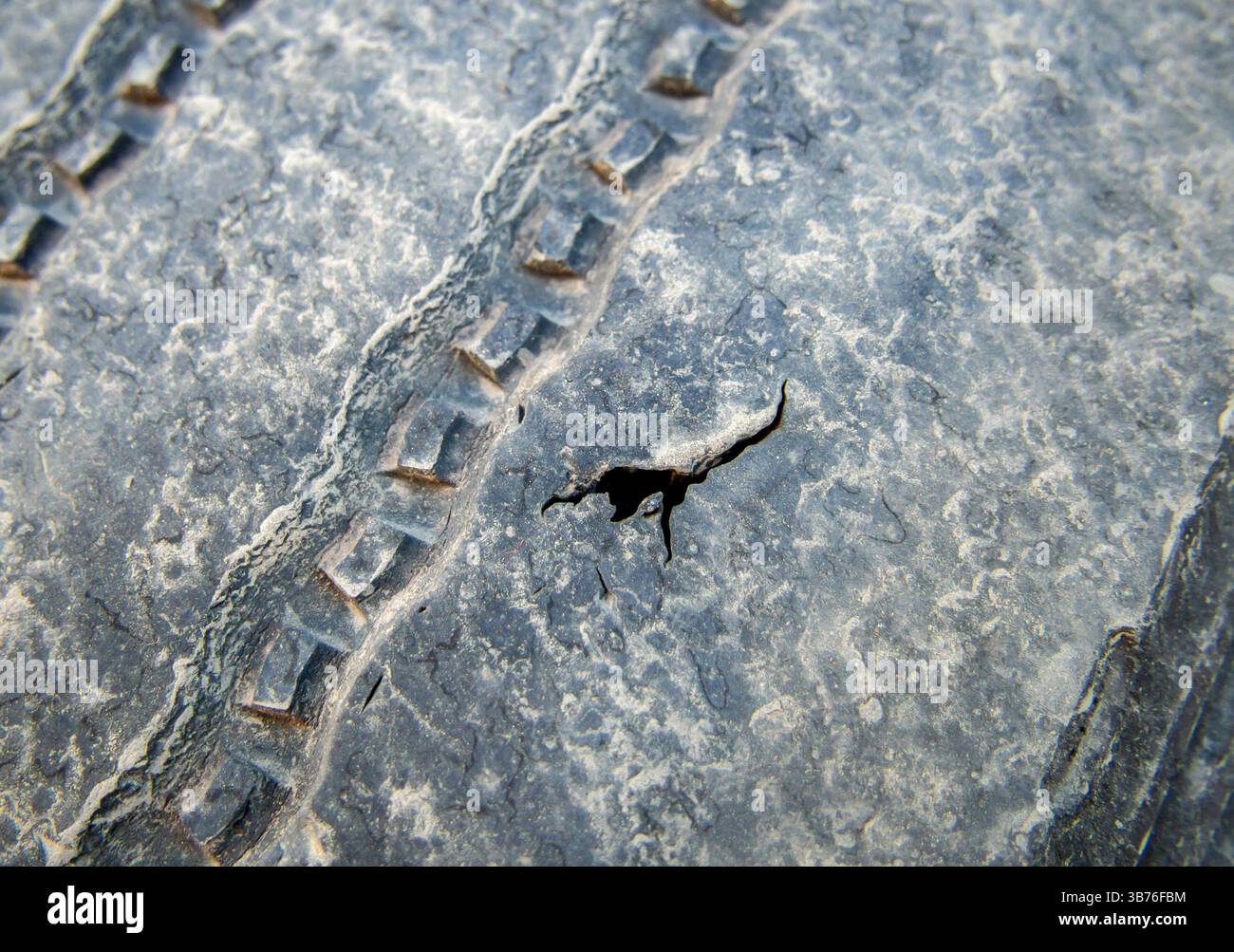 Puncture mark on an old car tire Stock Photo - Alamy