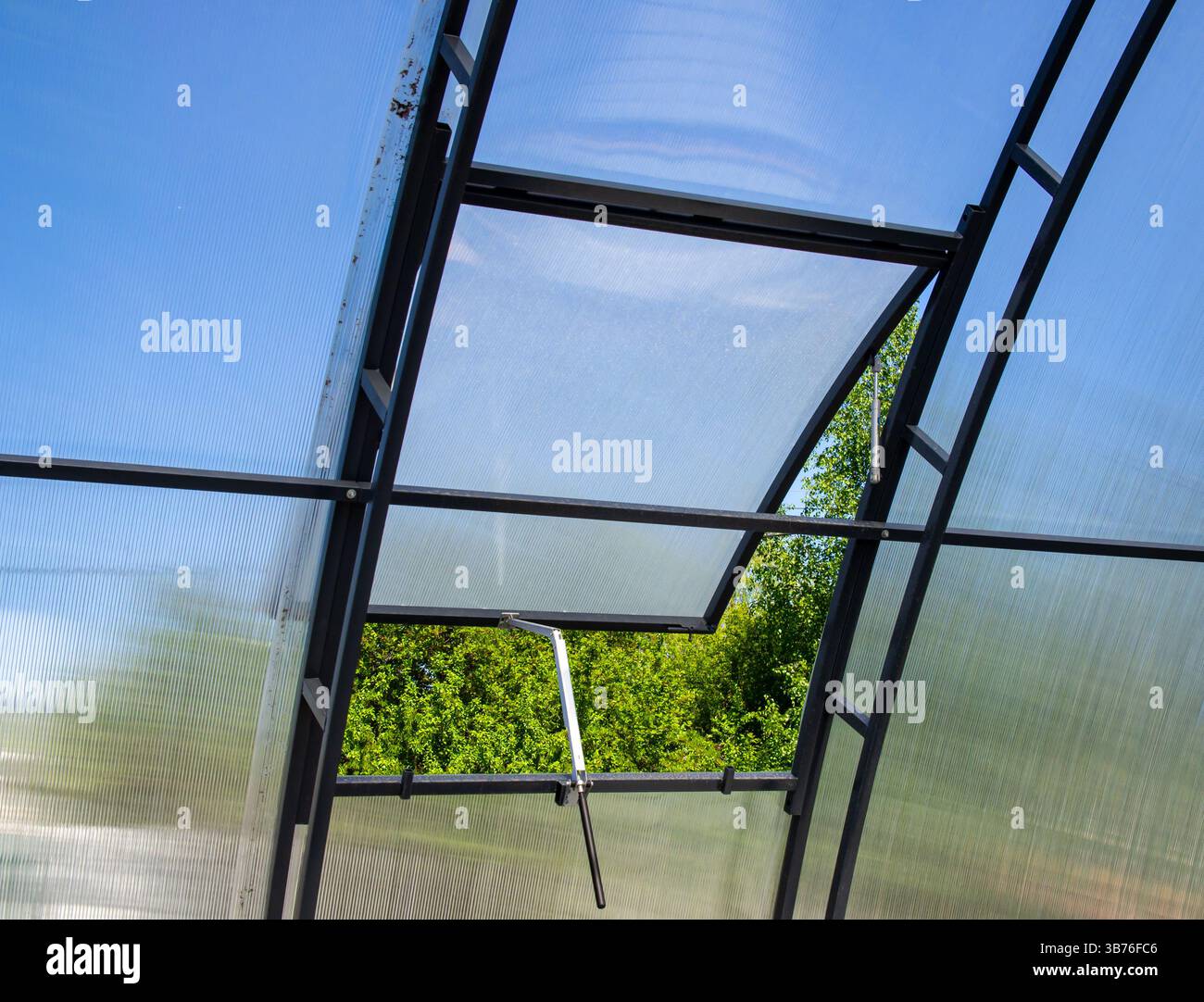 Automatic ventilation window of a modern greenhouse Stock Photo - Alamy