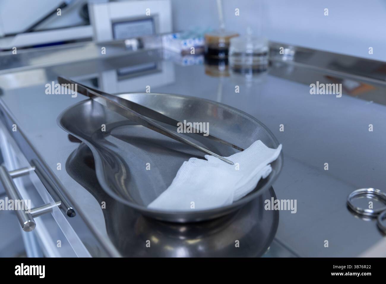 A close-up view of a stainless steel tray featuring surgical tools and ...