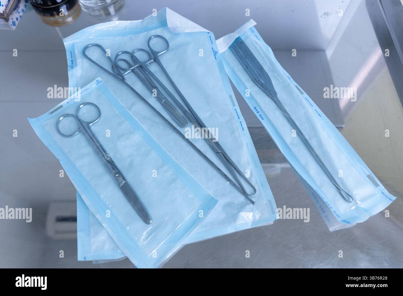 A collection of surgical instruments displayed on sterilized packaging ...