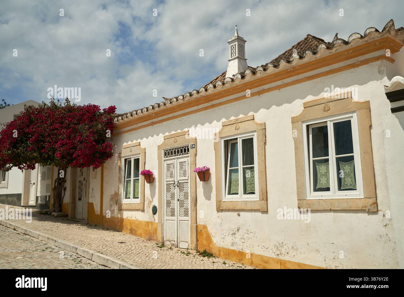 Typical colourfully painted traditional houses in the cobbled side ...