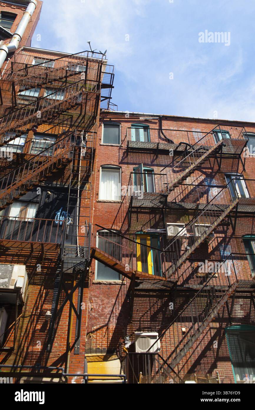 The typical american fire escape ladder zigzagging across the face and ...