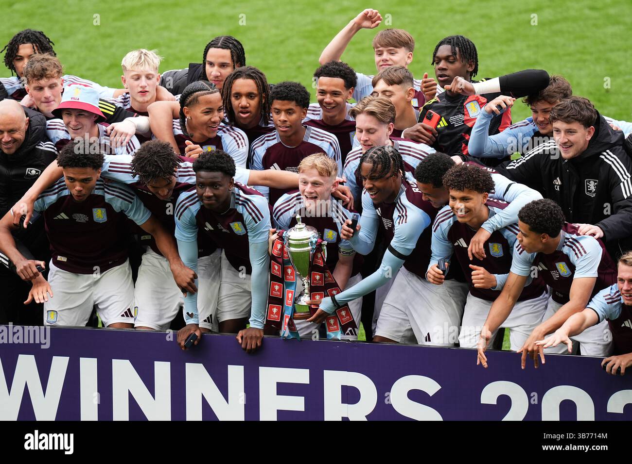 Aston Villa's Aidan Borland (centre) and team-mates lift the trophy as ...